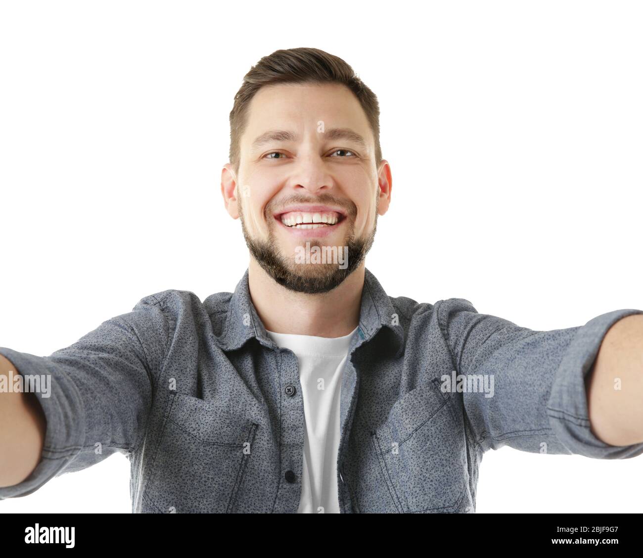 Handsome young man taking selfie on white background Stock Photo - Alamy