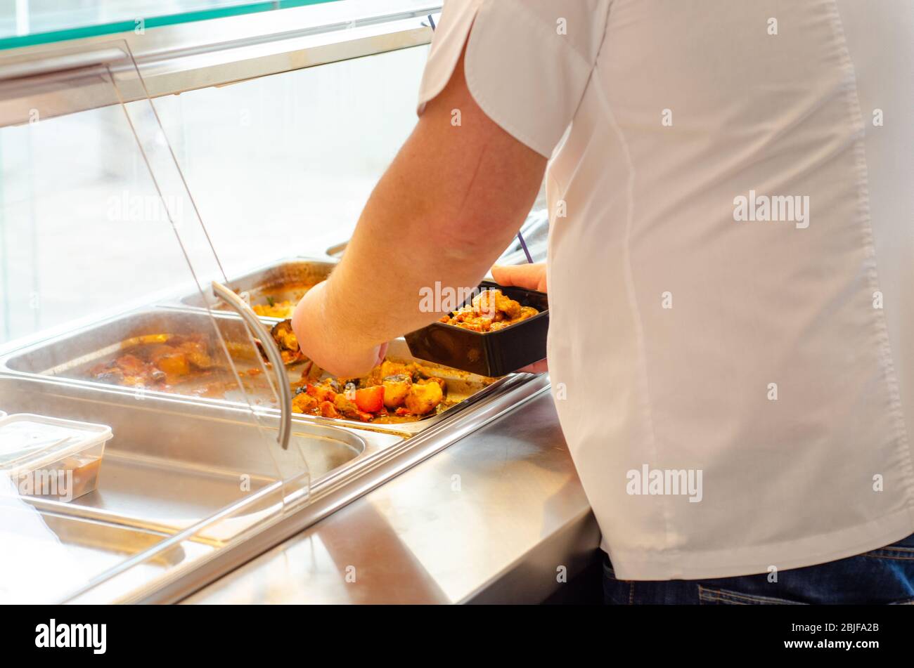 chef serves food in food containers Stock Photo - Alamy
