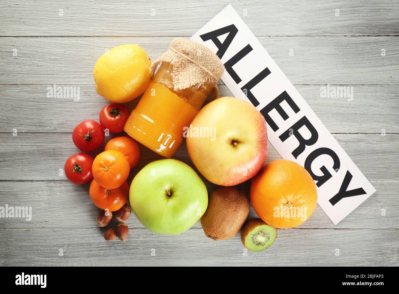 Paper sheet with text ALLERGY and food on wooden background Stock Photo ...