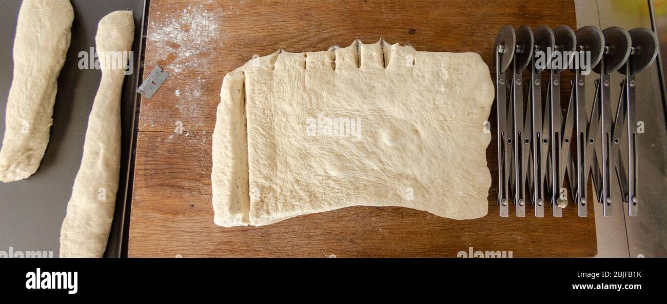 French dough baguette cutting roller tool Stock Photo - Alamy