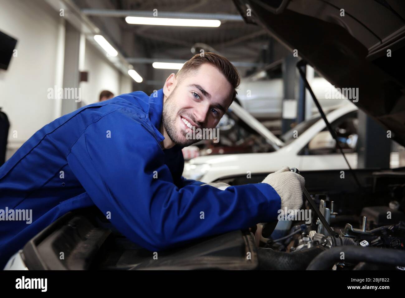 Male mechanic repairing car wheels hi-res stock photography and images ...