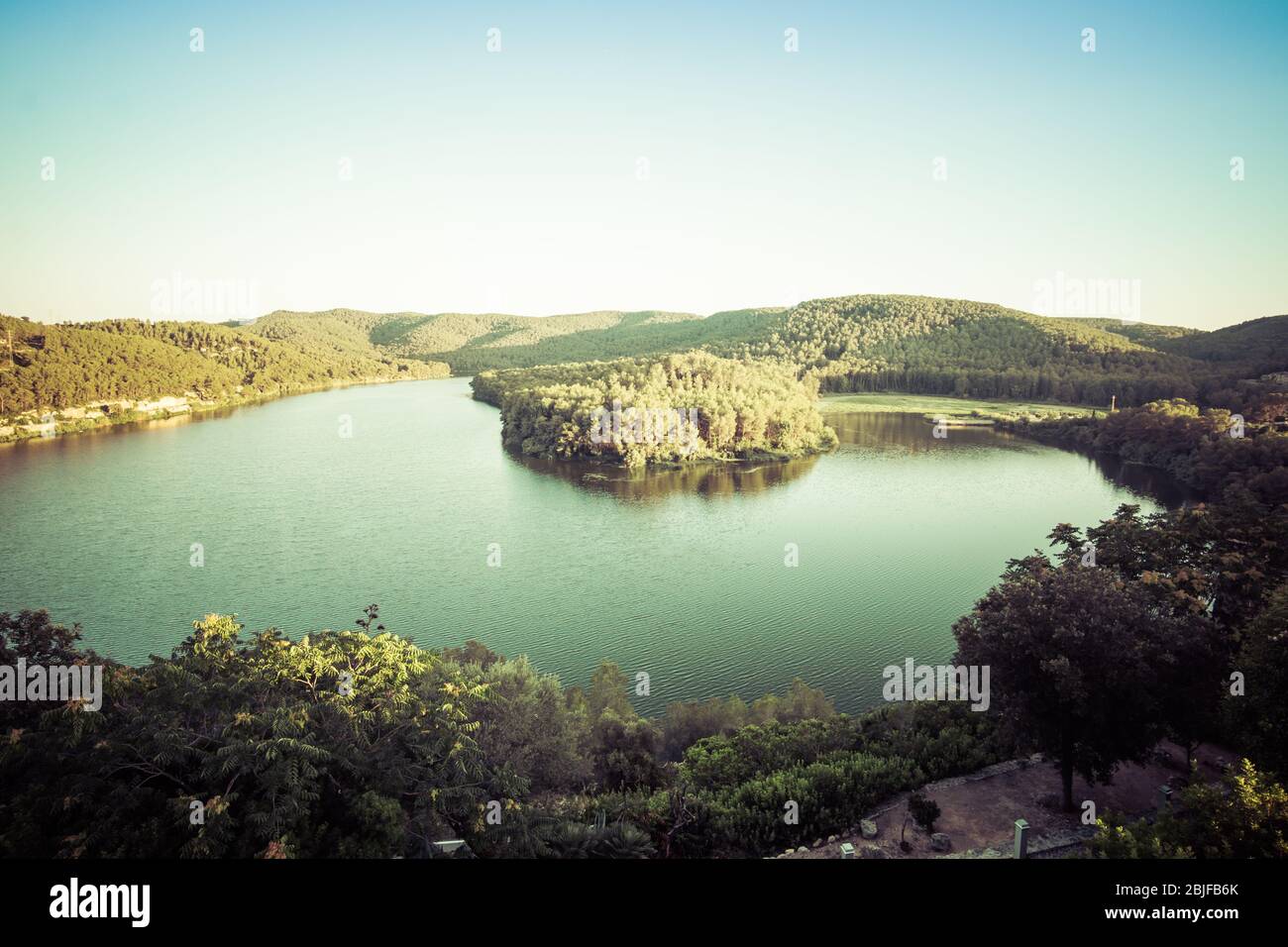 Unsaturated photo of the aerial view of a swamp surrounded by green ...