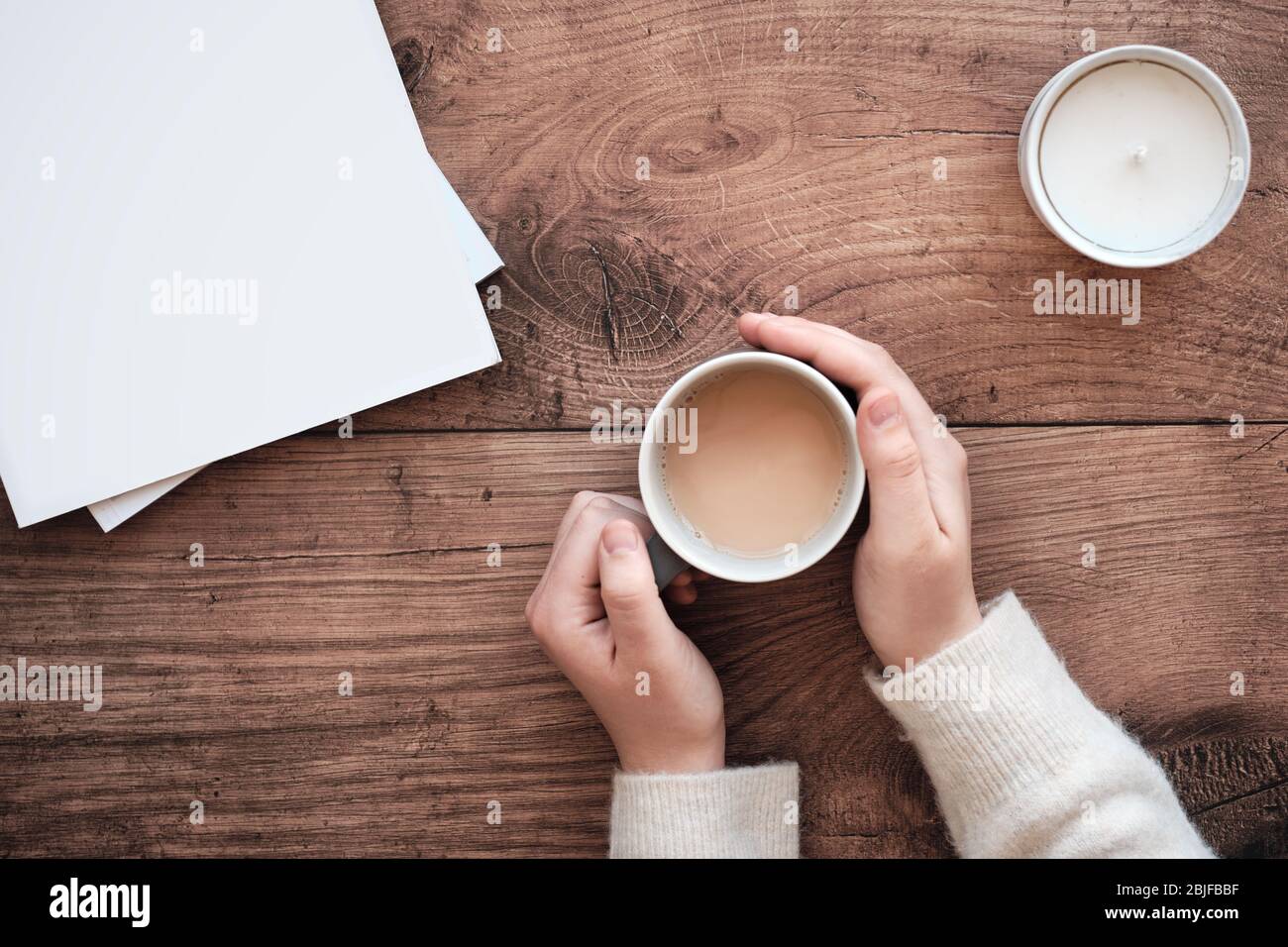 Top Down View of A Woman Holding a Coffee Mug on a Wooden desk with ...