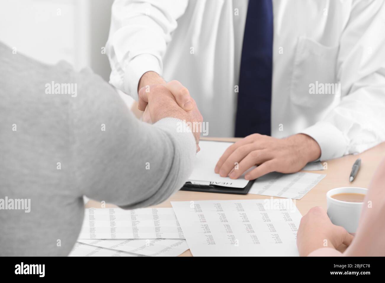 Woman signing contract shaking hands hi-res stock photography and ...