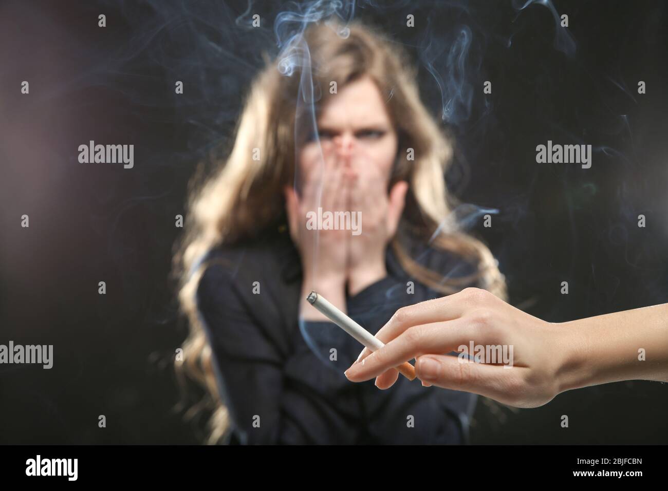 Woman covering face from cigarette smoke. Passive smoking concept Stock ...