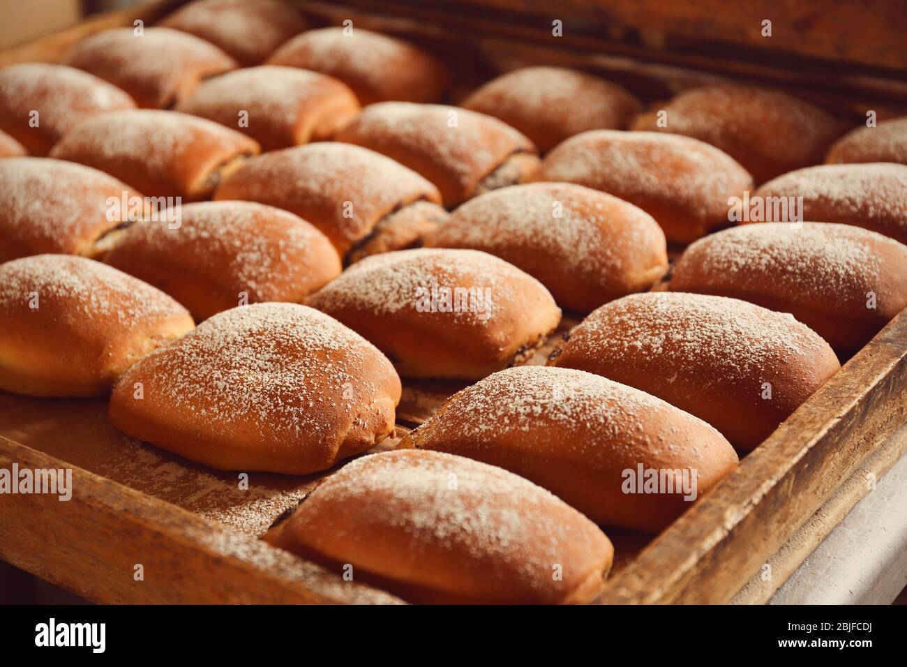 Wooden pallet with buns, closeup Stock Photo - Alamy