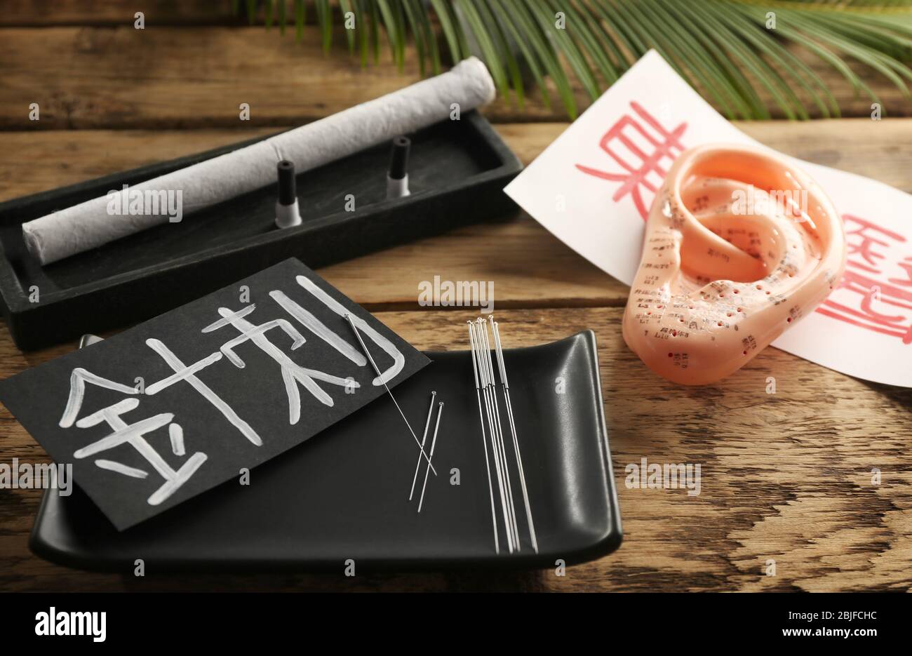 Acupuncture supplies on wooden table Stock Photo - Alamy