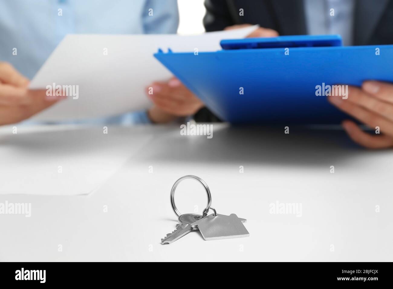 Key and blurred people on background Stock Photo - Alamy