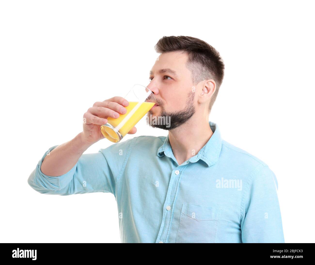 Handsome man posing with juice on white background Stock Photo - Alamy