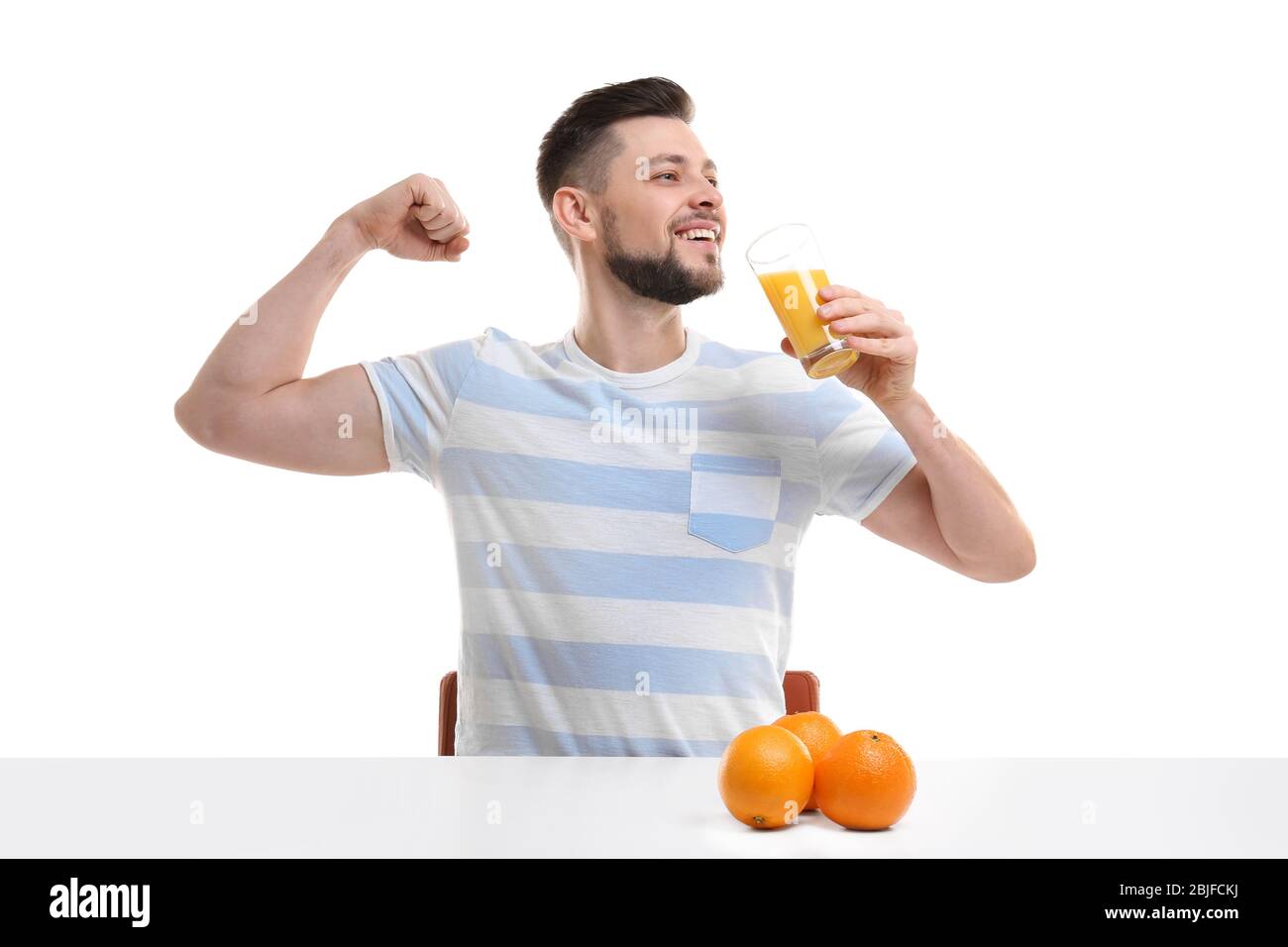 Handsome man posing with juice on white background Stock Photo - Alamy