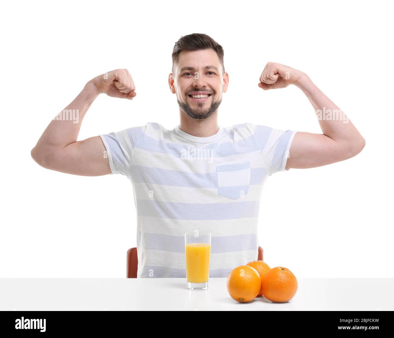 Handsome man posing with juice on white background Stock Photo - Alamy
