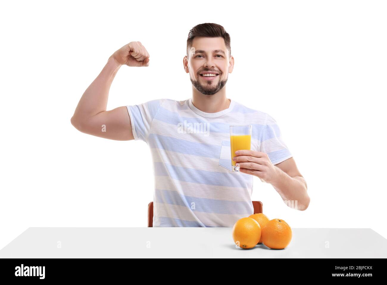 Handsome man posing with juice on white background Stock Photo - Alamy