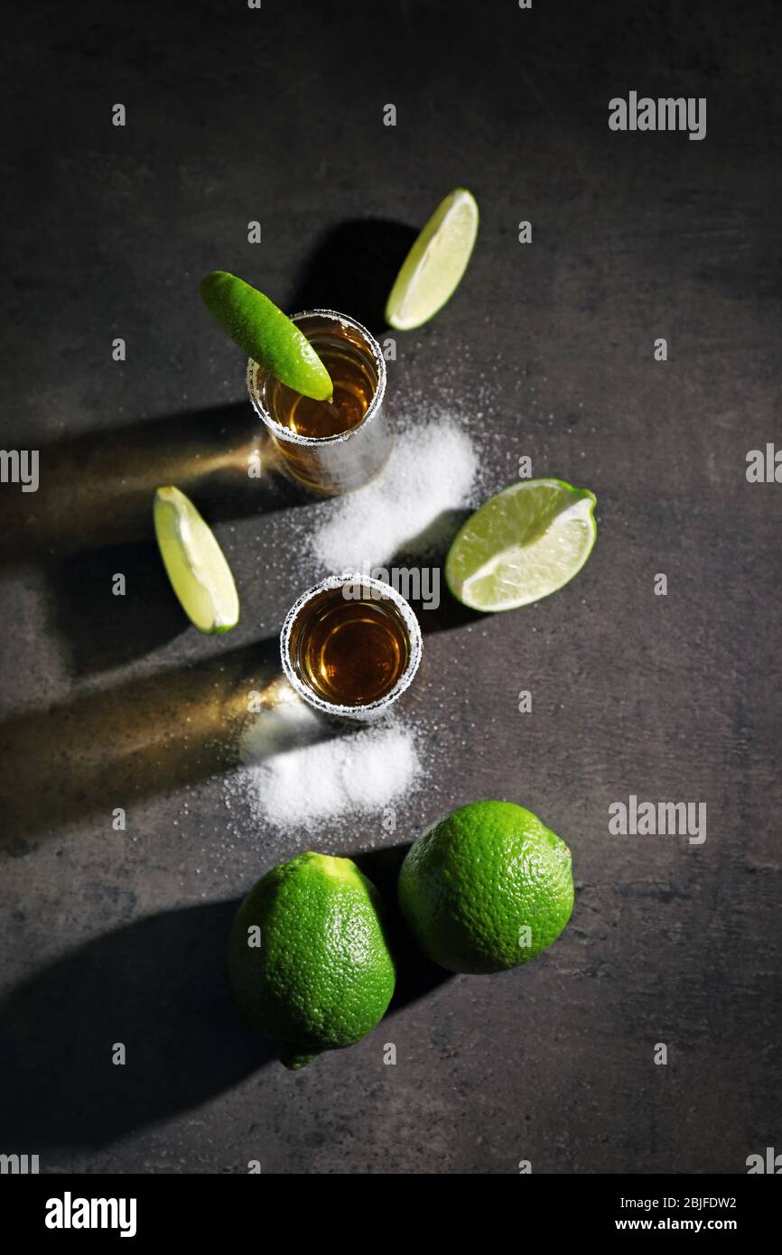 Tequila shots with lime slices and salt on table Stock Photo - Alamy