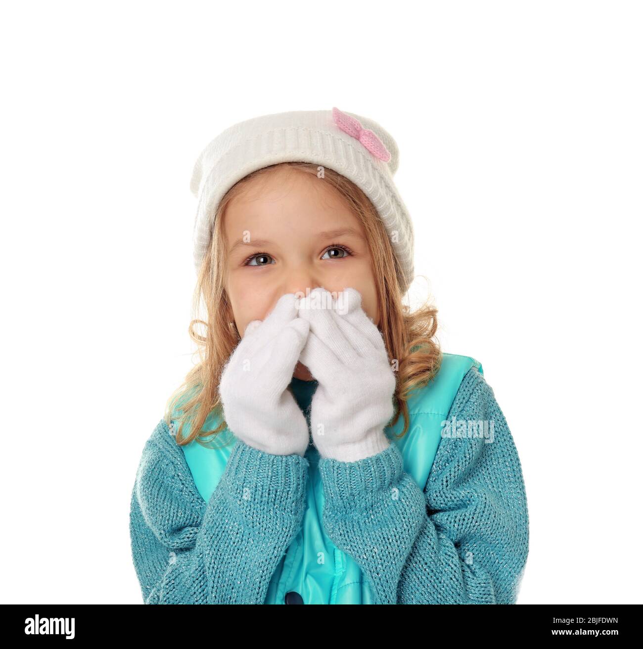 Cute little girl in warm clothes on white background Stock Photo - Alamy