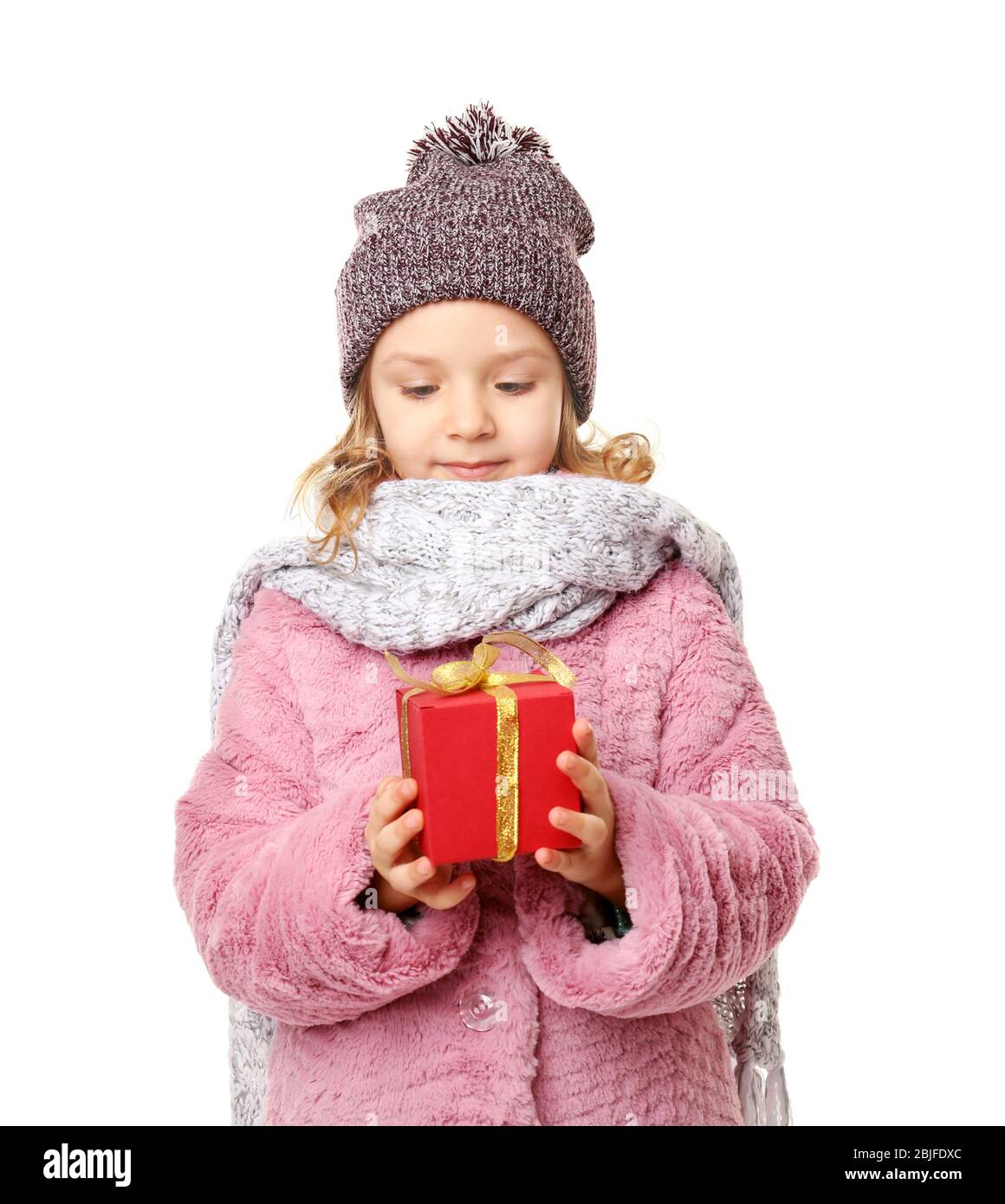 Cute little girl in warm clothes with giftbox on white background Stock ...