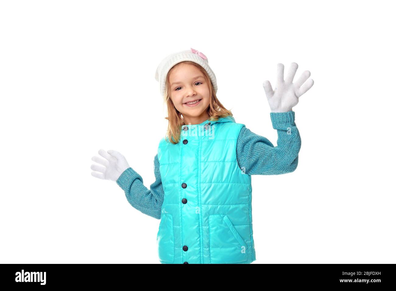 Cute little girl in warm clothes on white background Stock Photo - Alamy