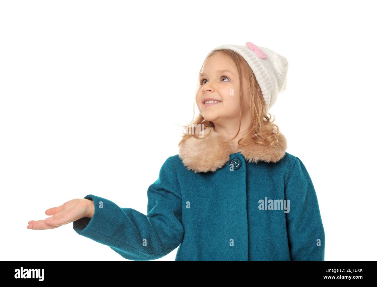 Cute little girl in warm clothes on white background Stock Photo - Alamy