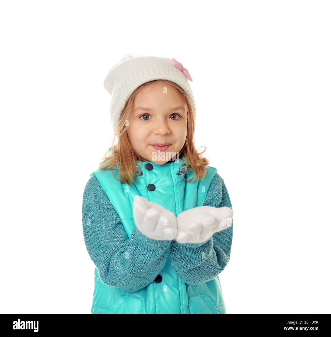 Cute little girl in warm clothes on white background Stock Photo - Alamy