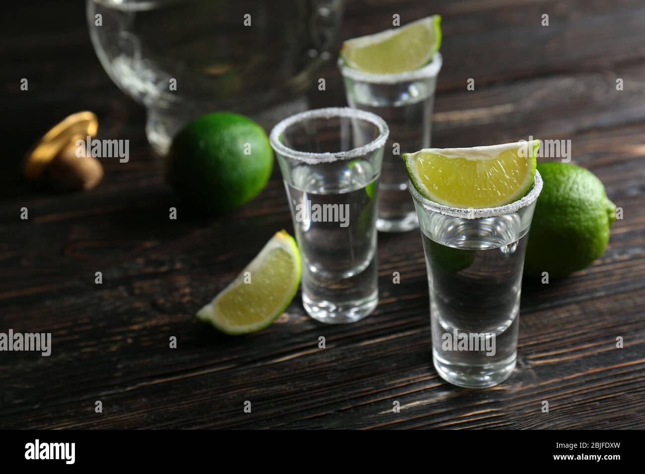 Tequila shots with lime slices and salt on table Stock Photo - Alamy
