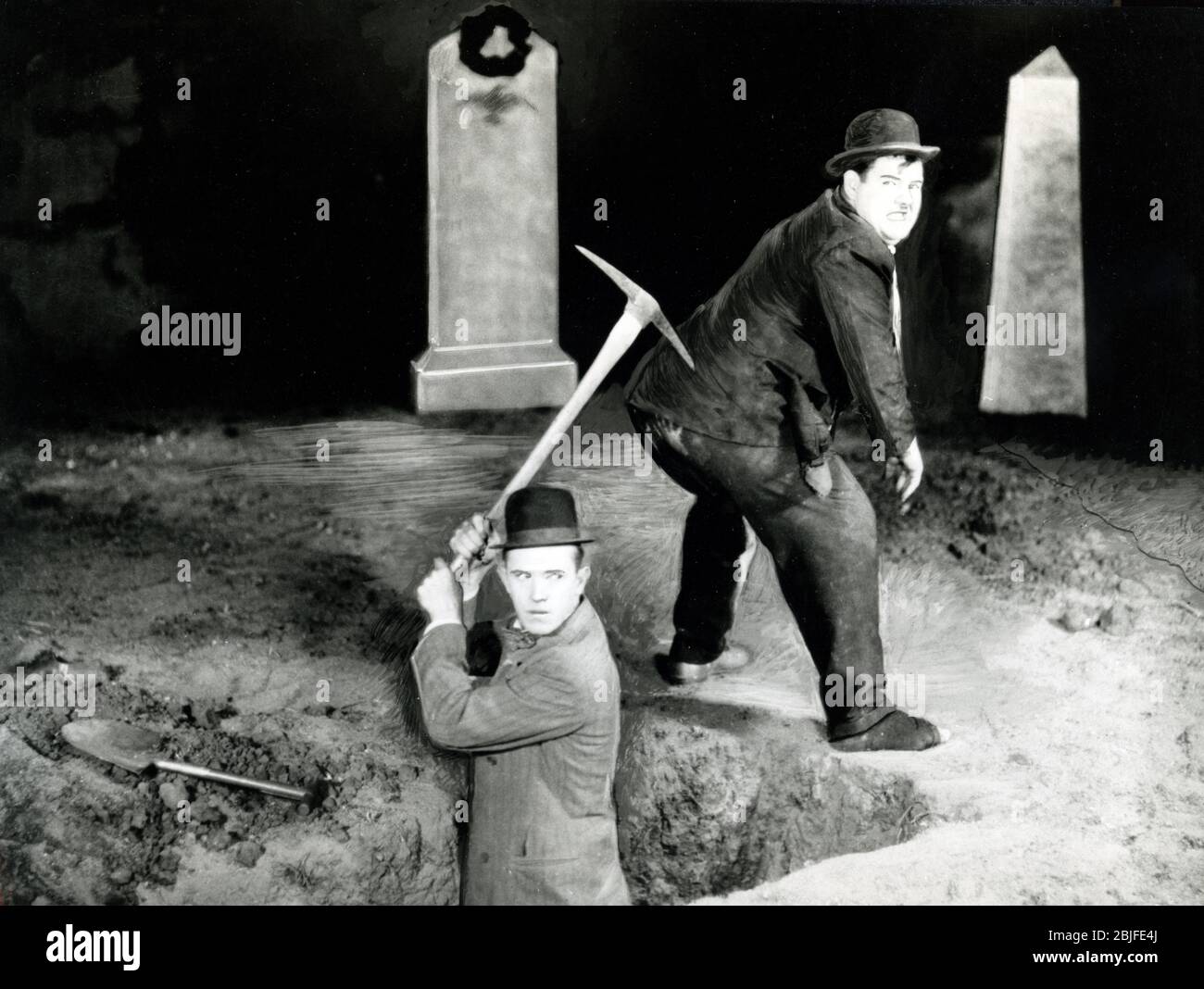Laurel and Hardy in graveyard in scene from a classic comedy movie ...