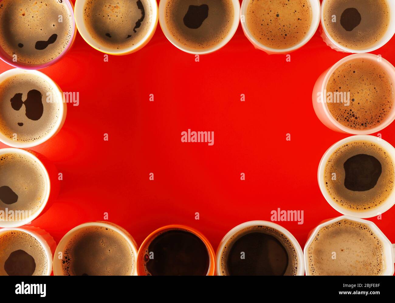 Cups of coffee on red background Stock Photo - Alamy