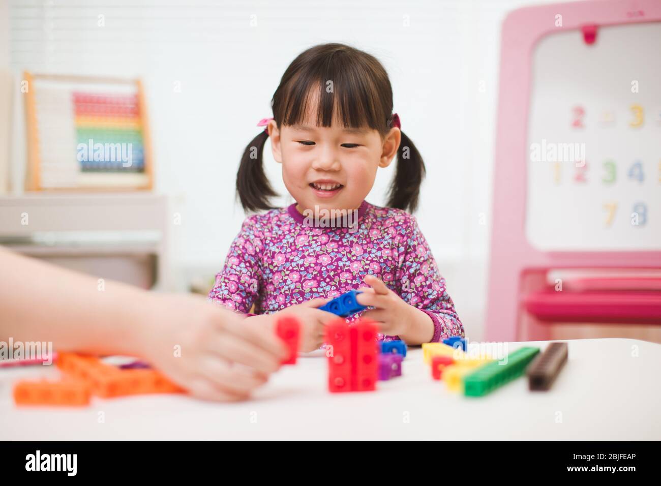 toddler girl play number blocks for homeschooling Stock Photo - Alamy