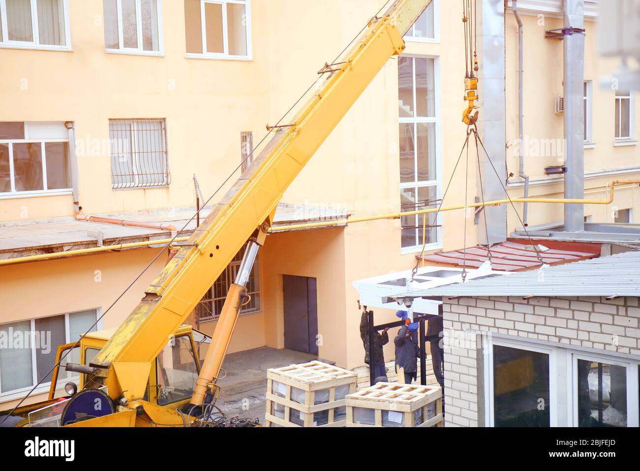 Industrial crane operating and lifting heavy object Stock Photo - Alamy