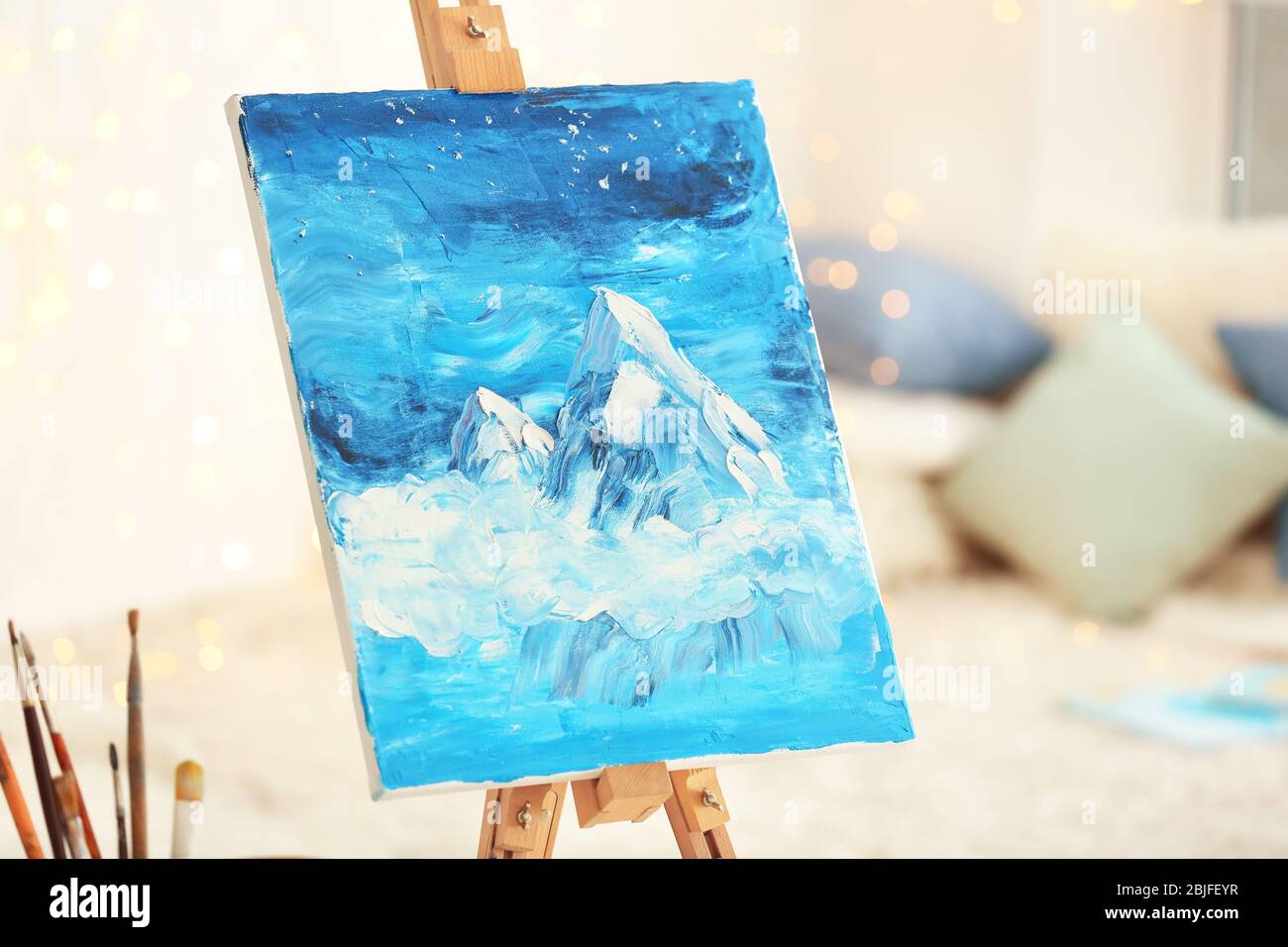Beautiful oil painting on easel in workshop Stock Photo - Alamy