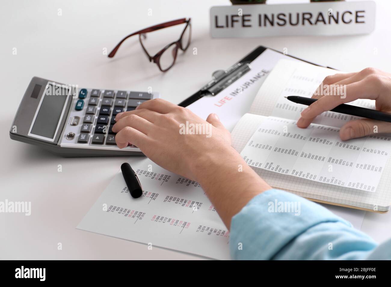 Life planning concept. Hands of insurance agent at workplace Stock ...