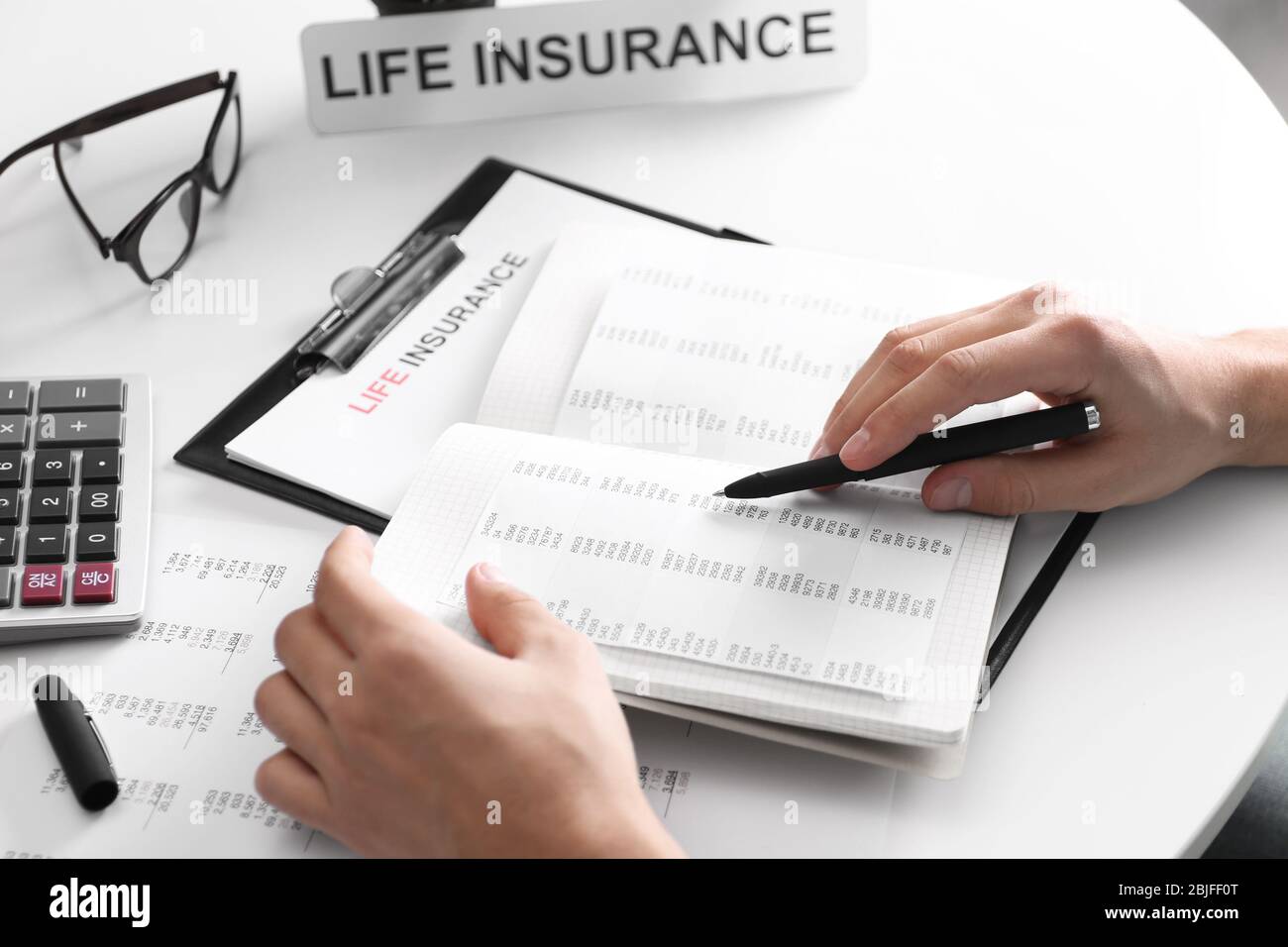 Life planning concept. Hands of insurance agent at workplace Stock ...