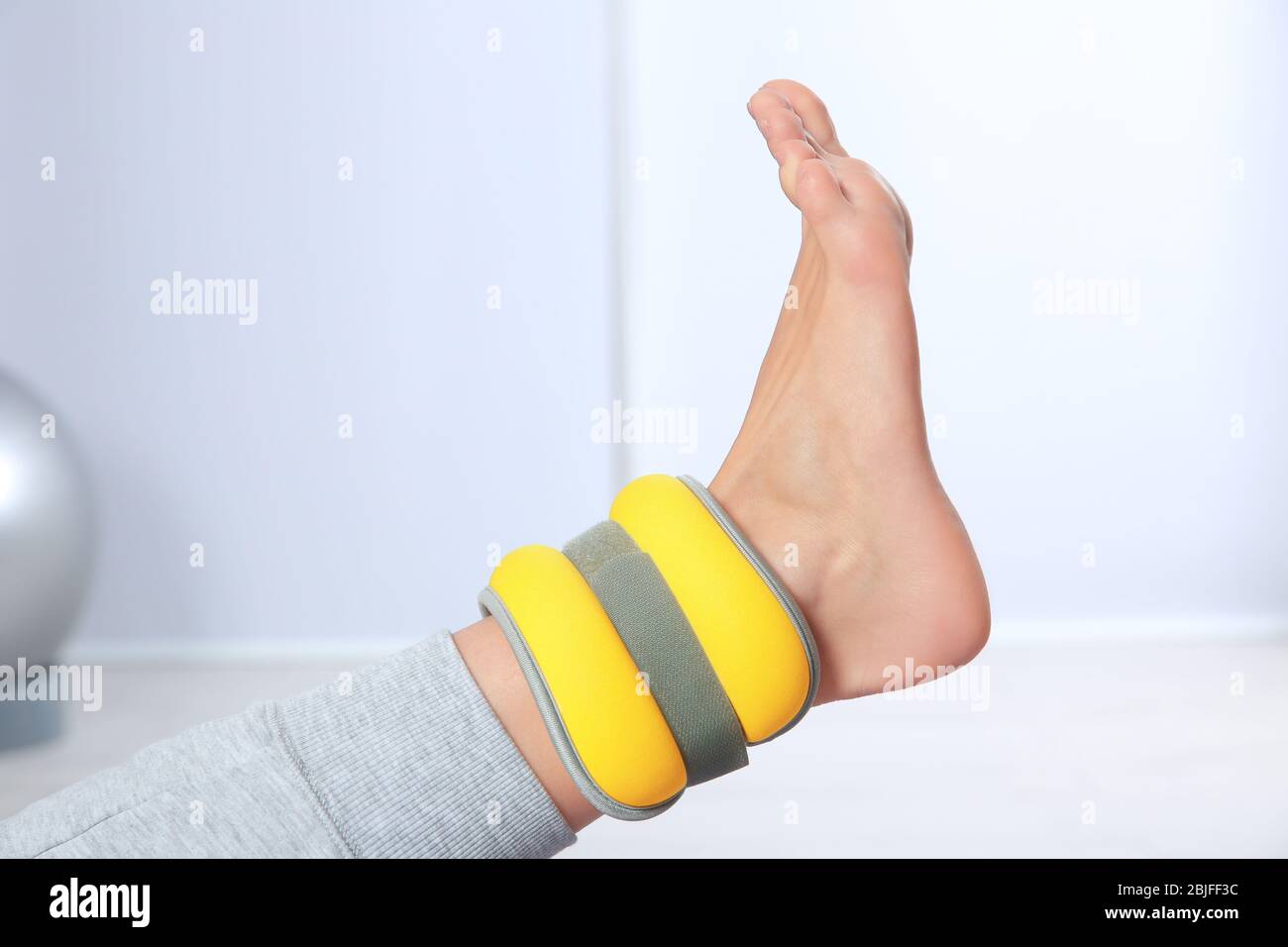 Female leg with weight, closeup Stock Photo - Alamy