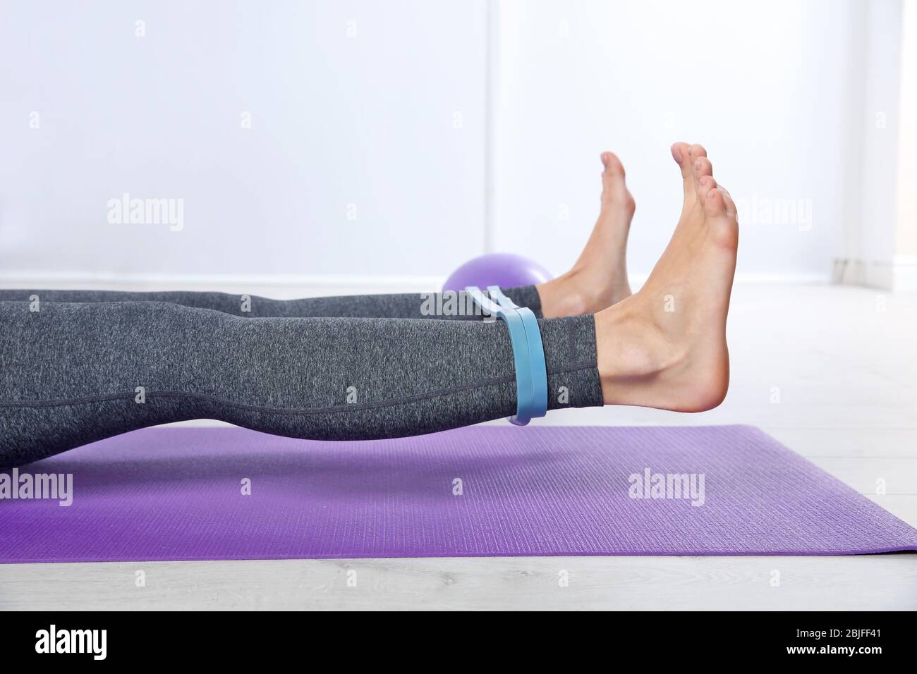 Female legs training with elastic in gym Stock Photo - Alamy