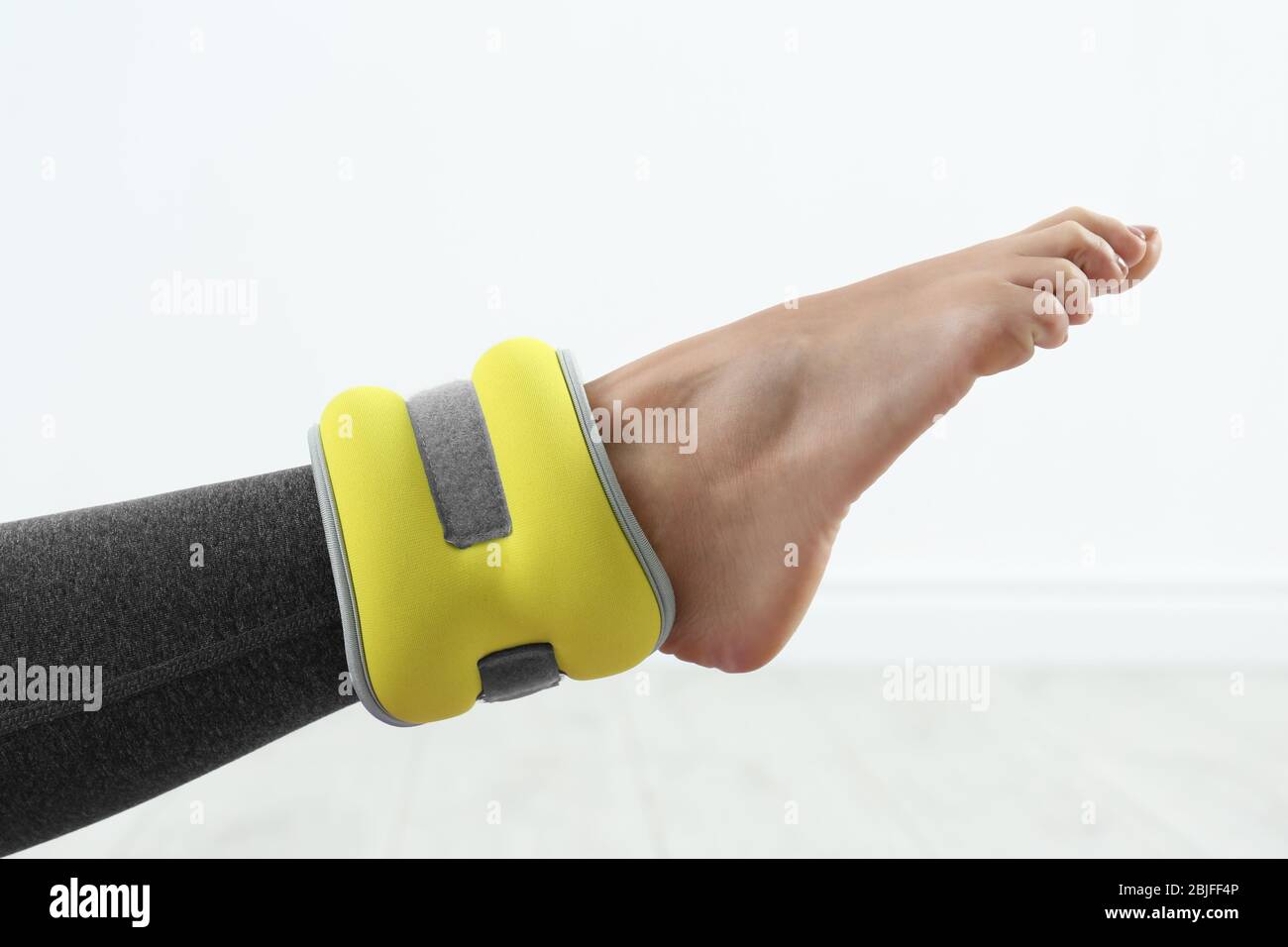 Female leg with weight, closeup Stock Photo - Alamy