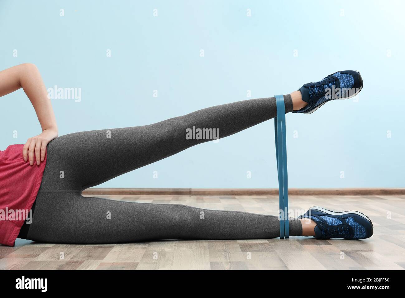 Female legs training with elastic in gym Stock Photo - Alamy