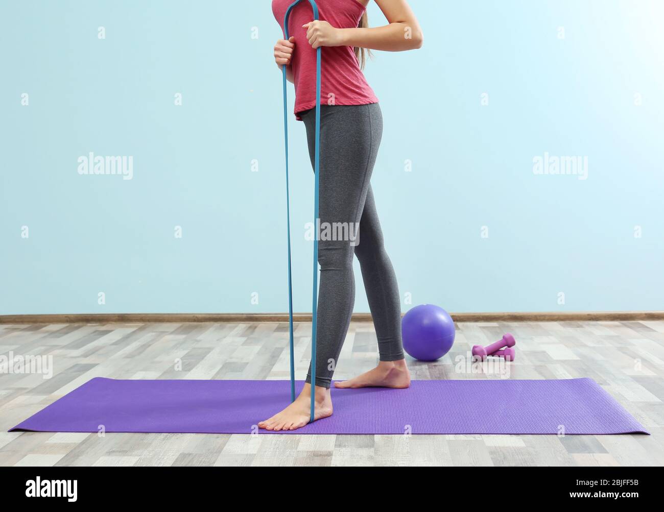 Girl training with elastic in gym Stock Photo - Alamy
