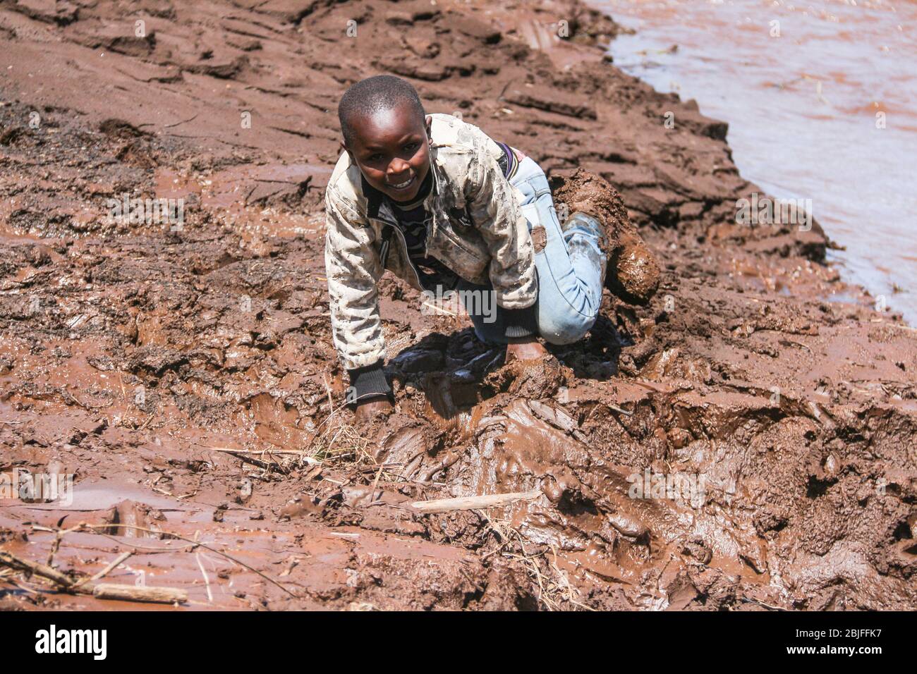 A boy tries to crawl out of the mud after walking proved futile, rains ...