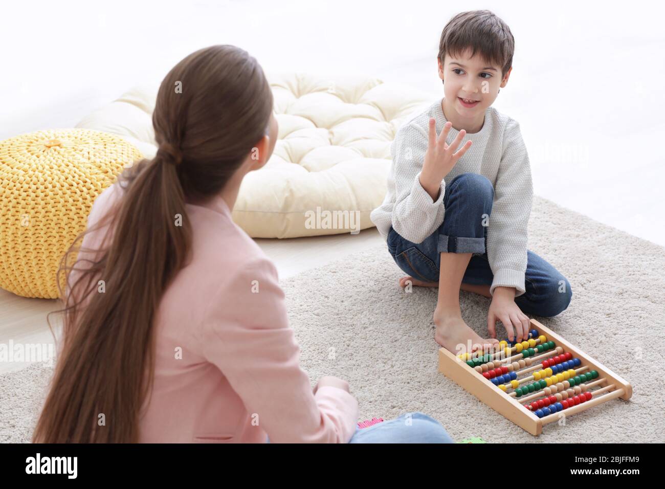 Cute little boy learning to count at private teacher's office Stock ...