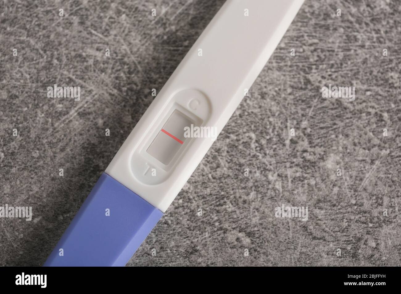 Pregnancy test on grey background Stock Photo - Alamy