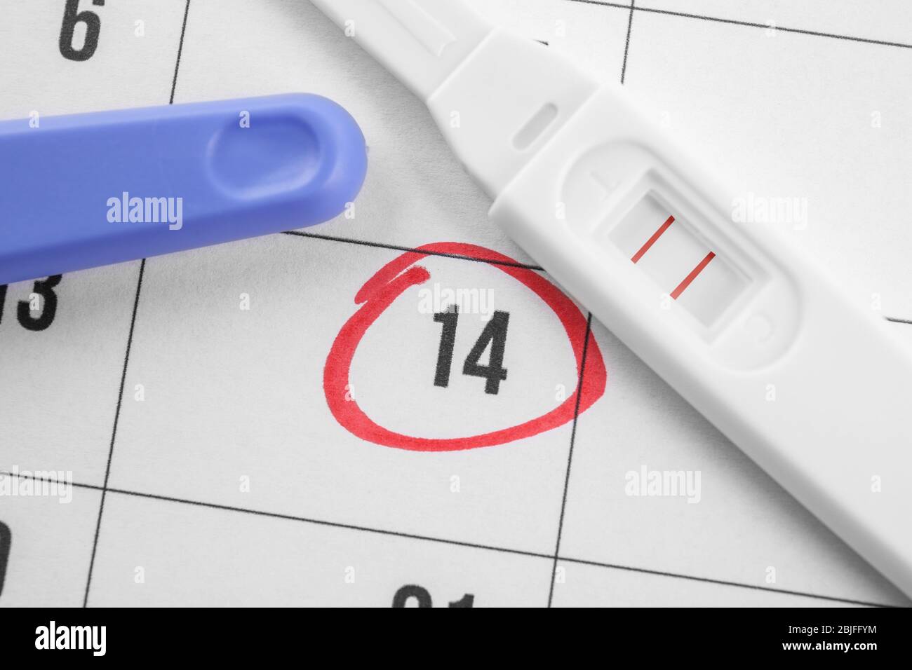 Pregnancy test and marked date on calendar Stock Photo - Alamy