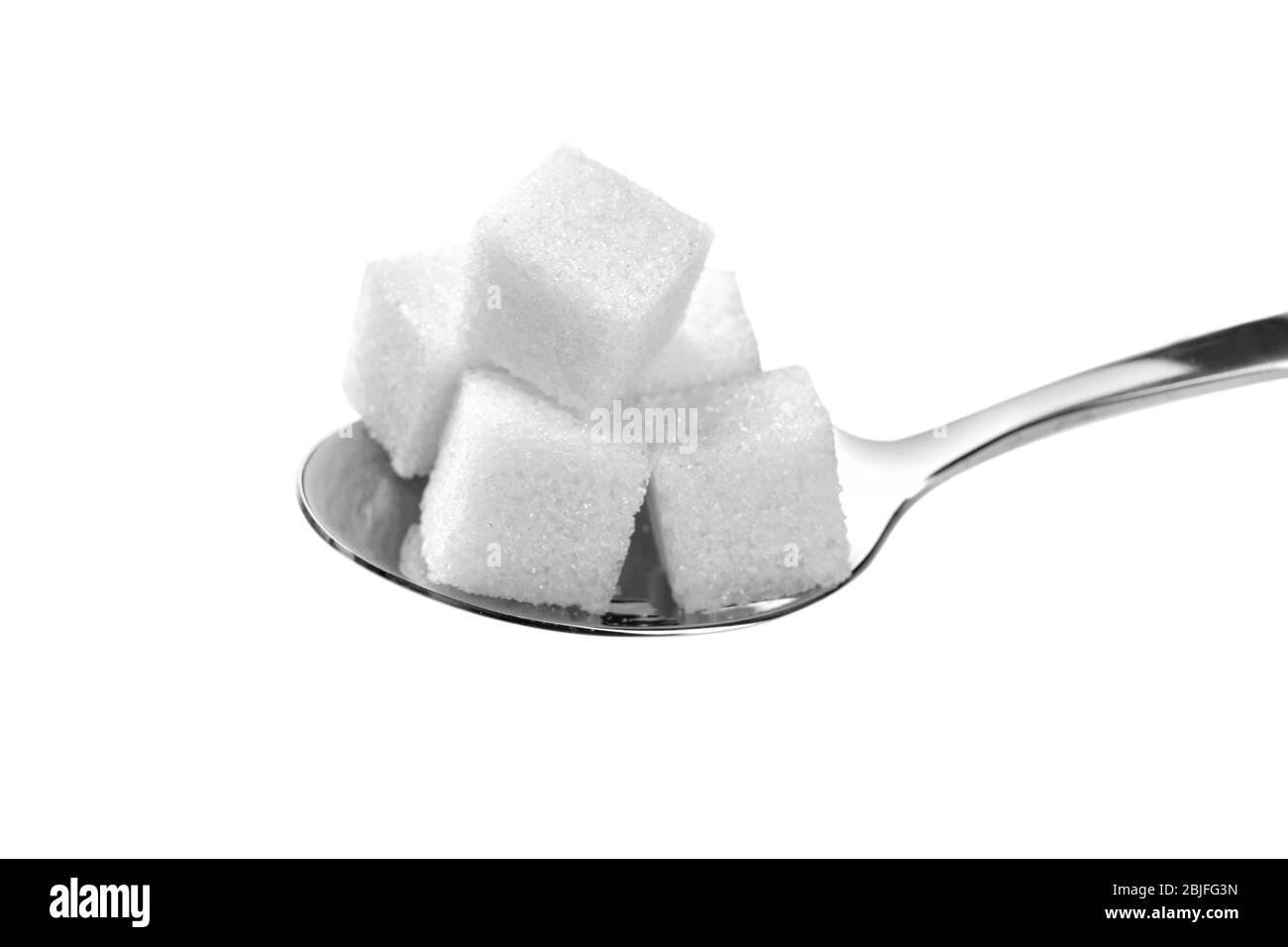 Sugar cubes in spoon on white background Stock Photo - Alamy