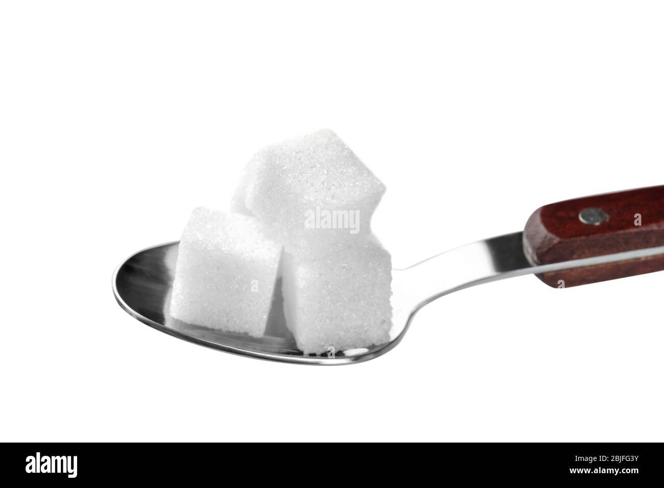 Sugar cubes in spoon on white background Stock Photo - Alamy