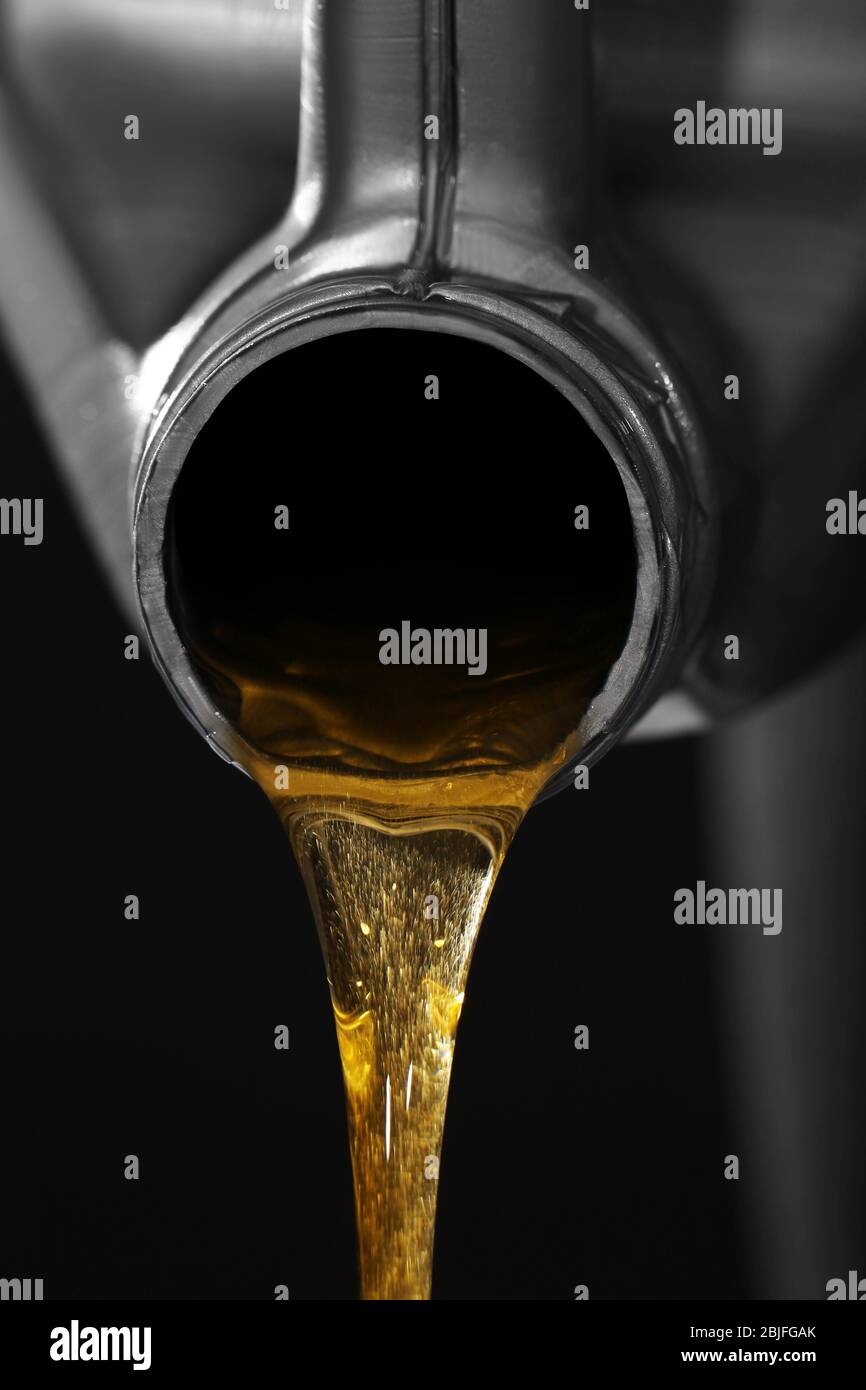 Engine oil pouring from canister, closeup Stock Photo - Alamy