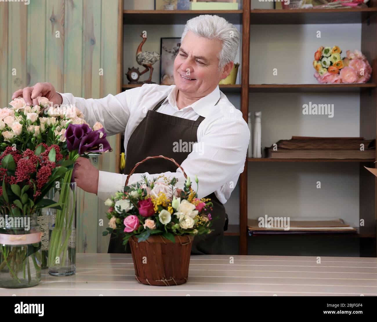 Mature florist man flower basket hi-res stock photography and images ...