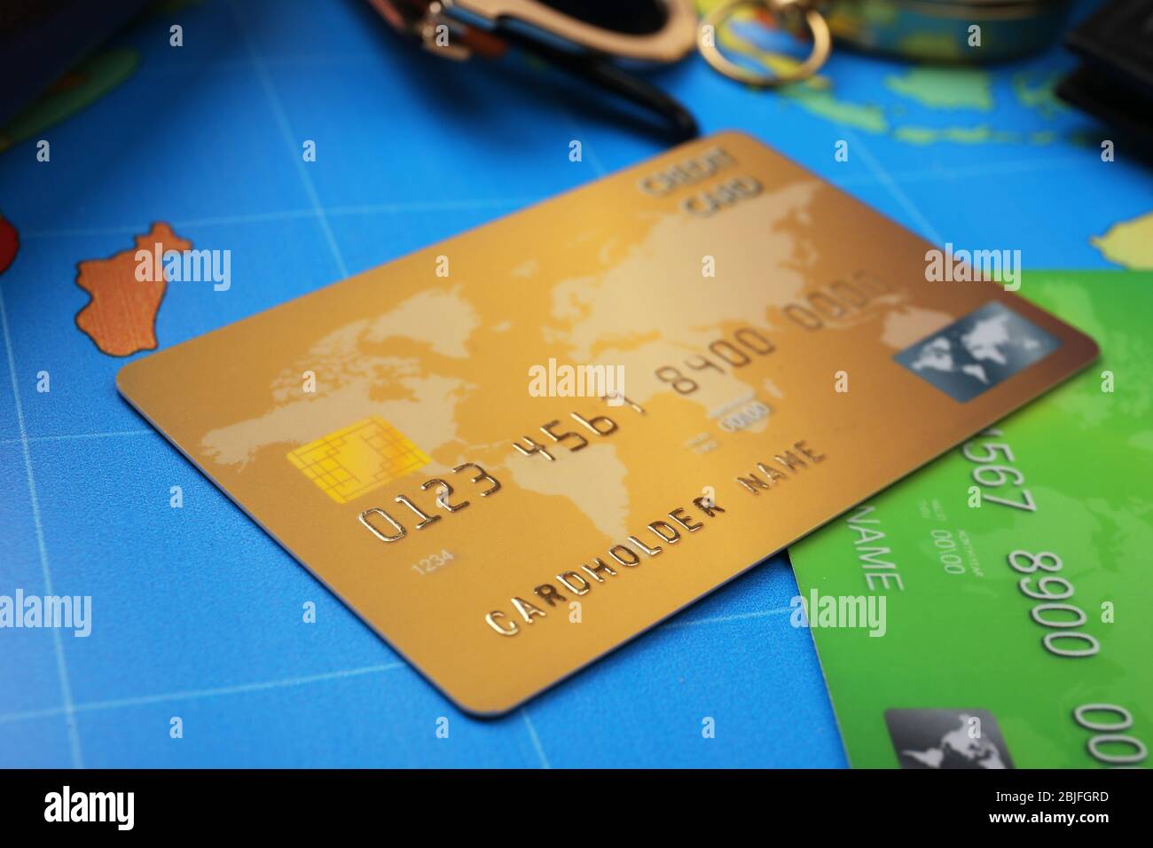 Credit cards on world map background Stock Photo - Alamy