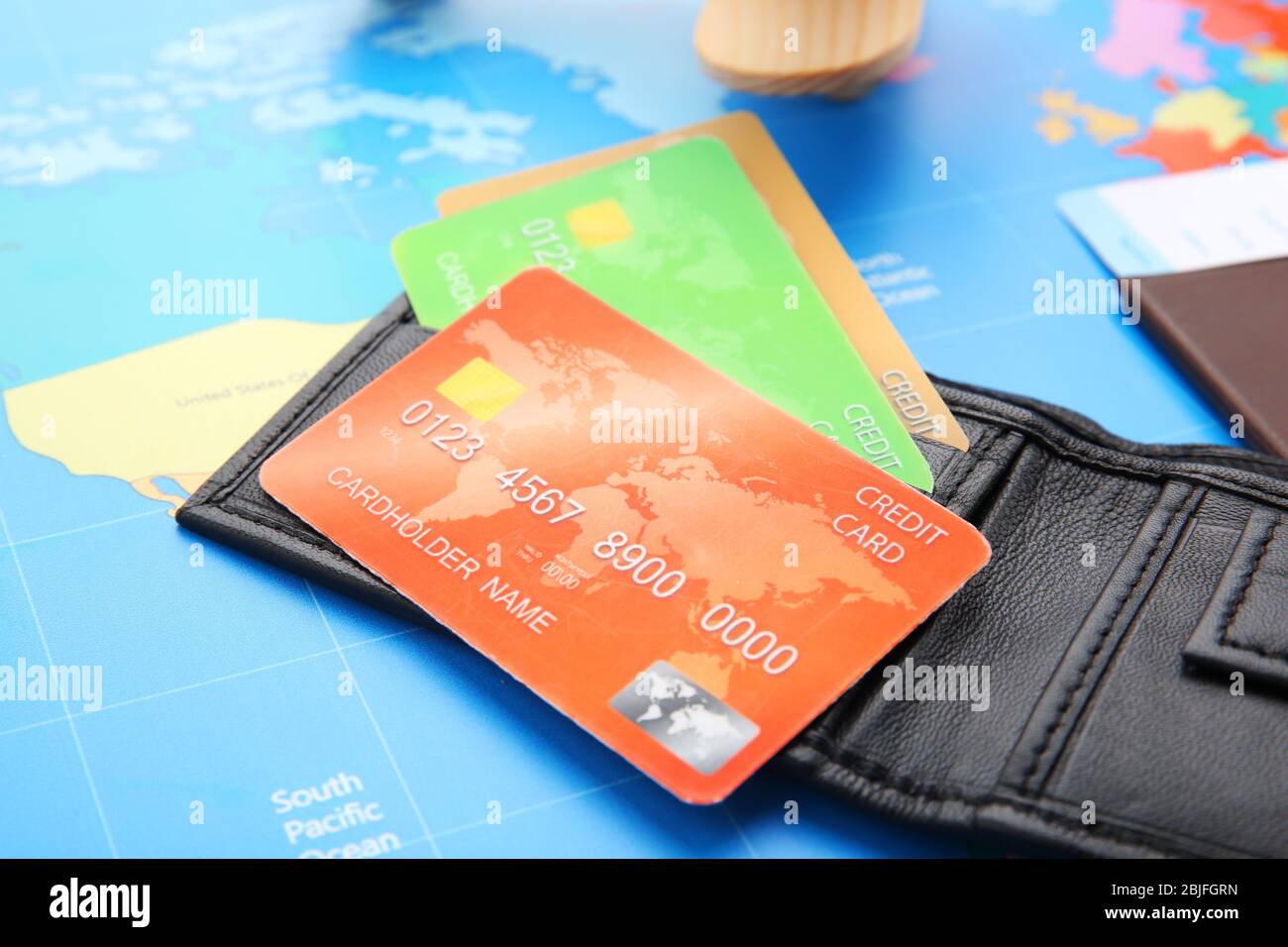 Credit cards with wallet on world map background Stock Photo - Alamy