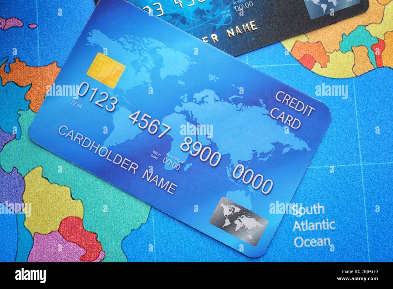 Credit cards on world map background Stock Photo - Alamy