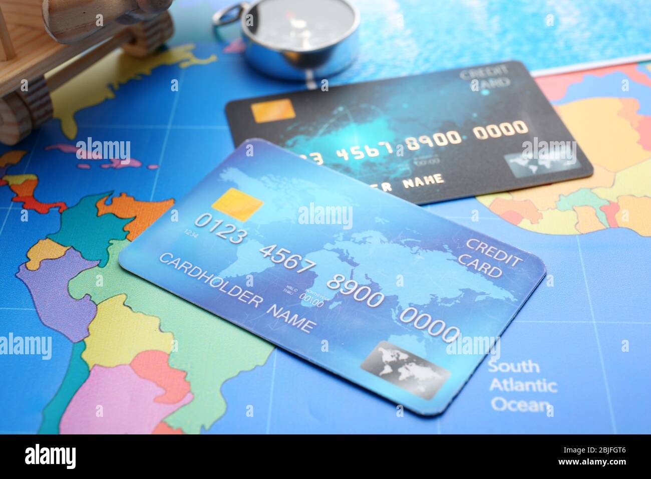 Credit cards on world map background Stock Photo - Alamy