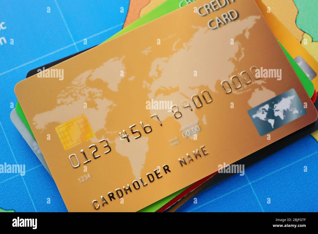 Credit cards on world map background Stock Photo - Alamy