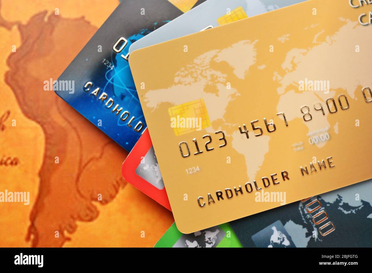Credit cards on world map background Stock Photo - Alamy