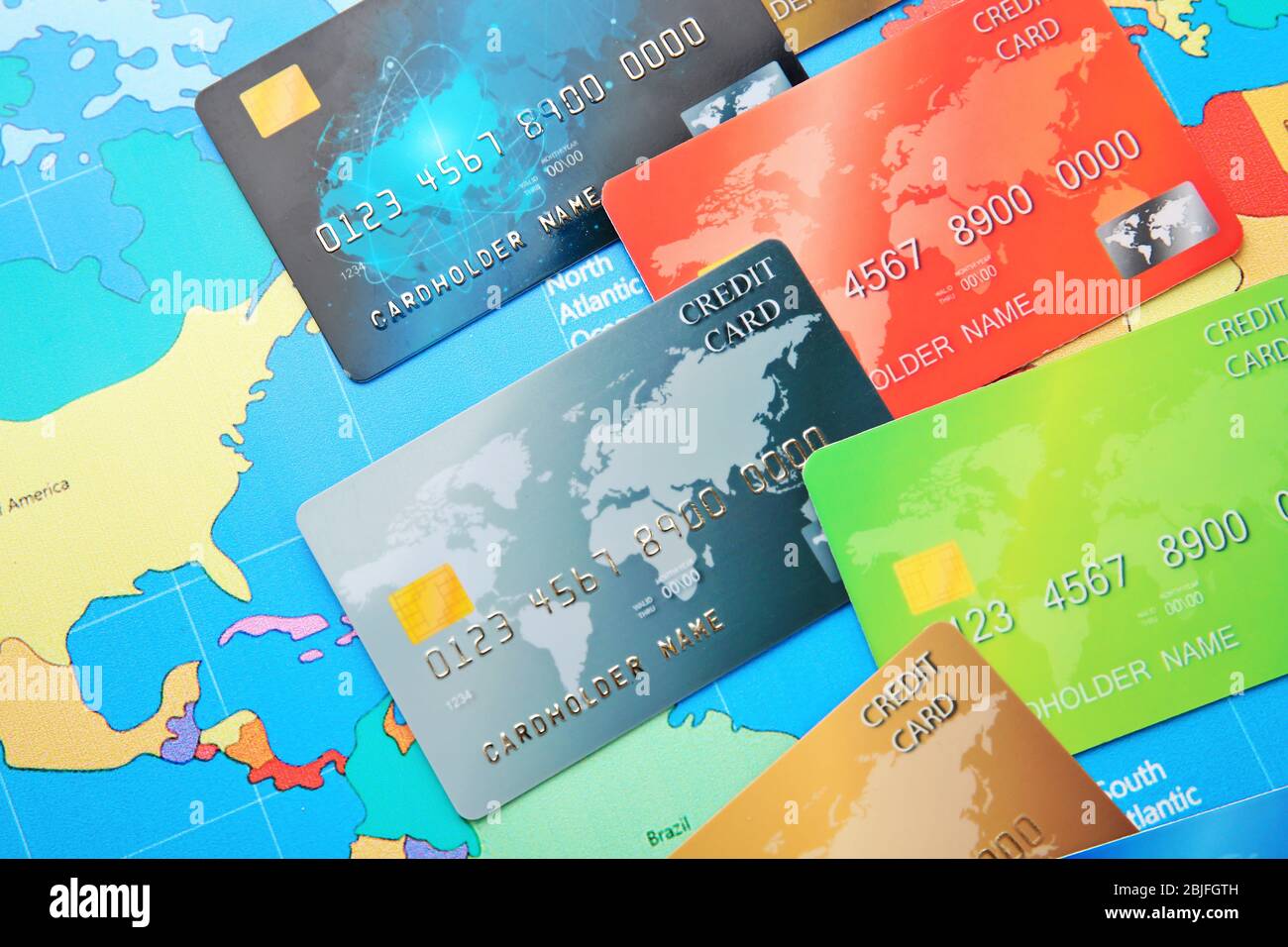 Credit cards on world map background Stock Photo - Alamy